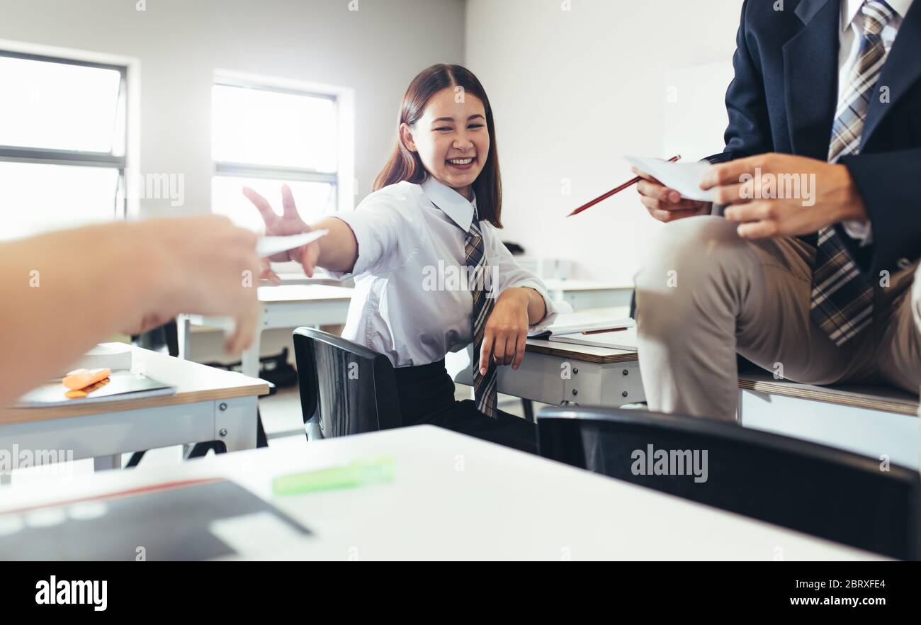 Classmates having fun during free period in classroom. Boys and girls ...