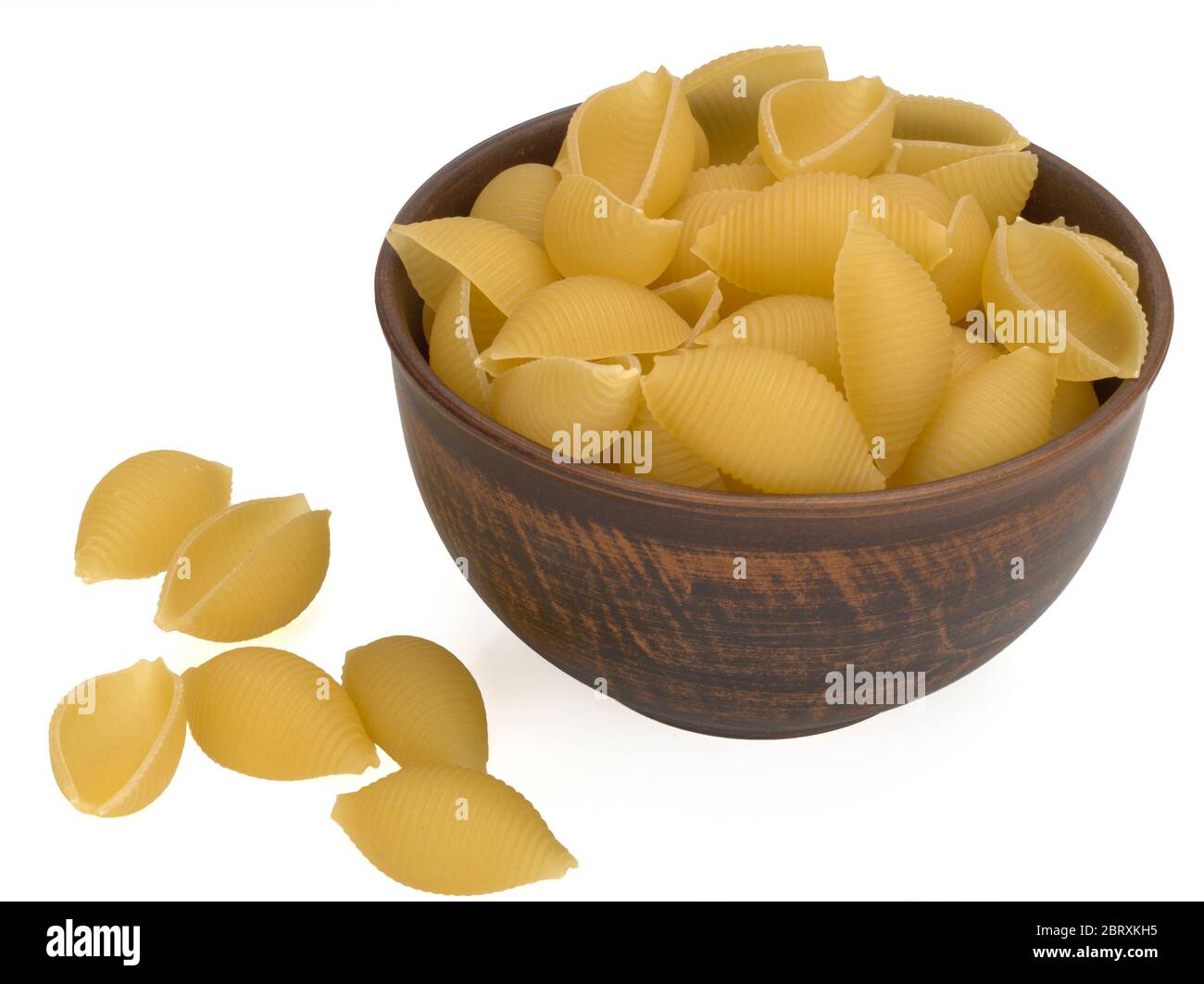 Italy dry raw pasta conchiglie in a bowl and on white background Stock ...