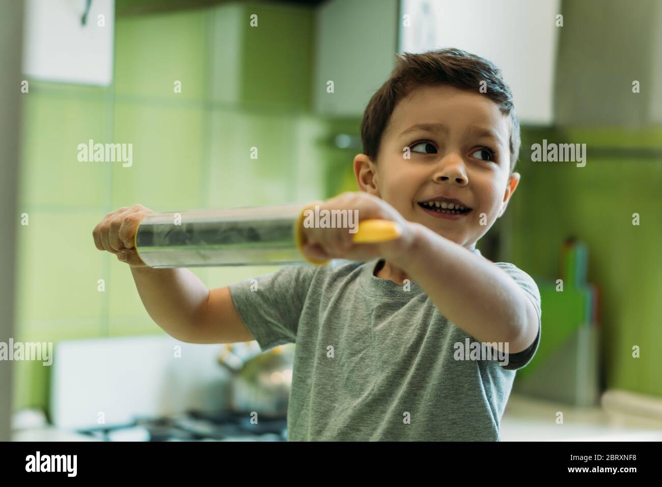 selective focus of happy toddler boy holding rolling pin Stock Photo ...