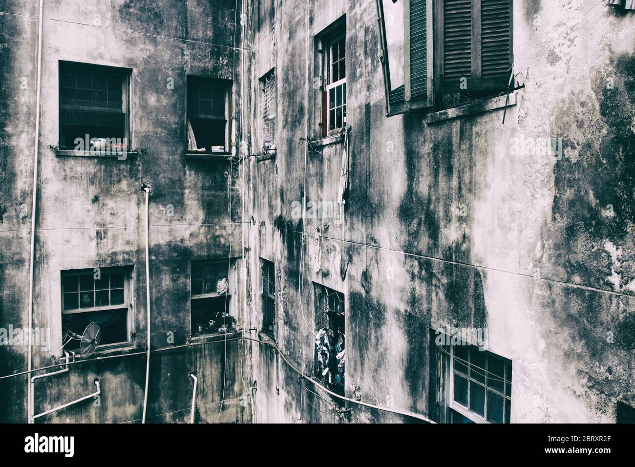 A ruined abandoned c shape building with square windows in San Paolo ...