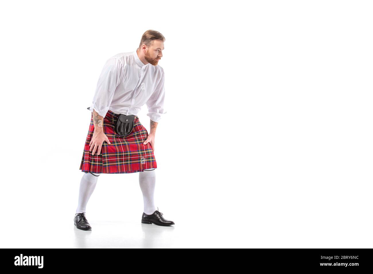 Scottish redhead man in red kilt in pose on white background Stock ...