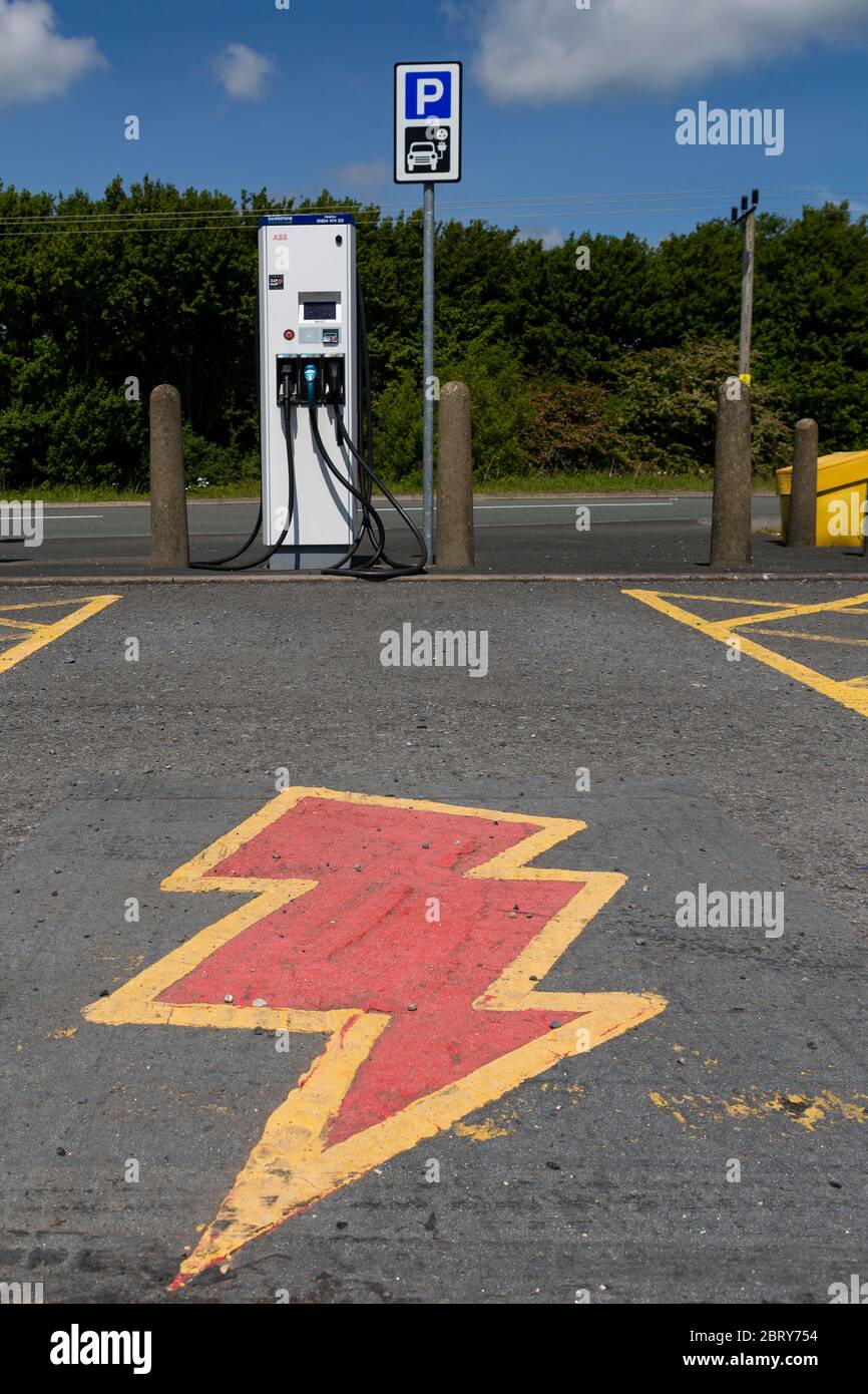 Electric car charging point with lightning symbol painted on ground ...