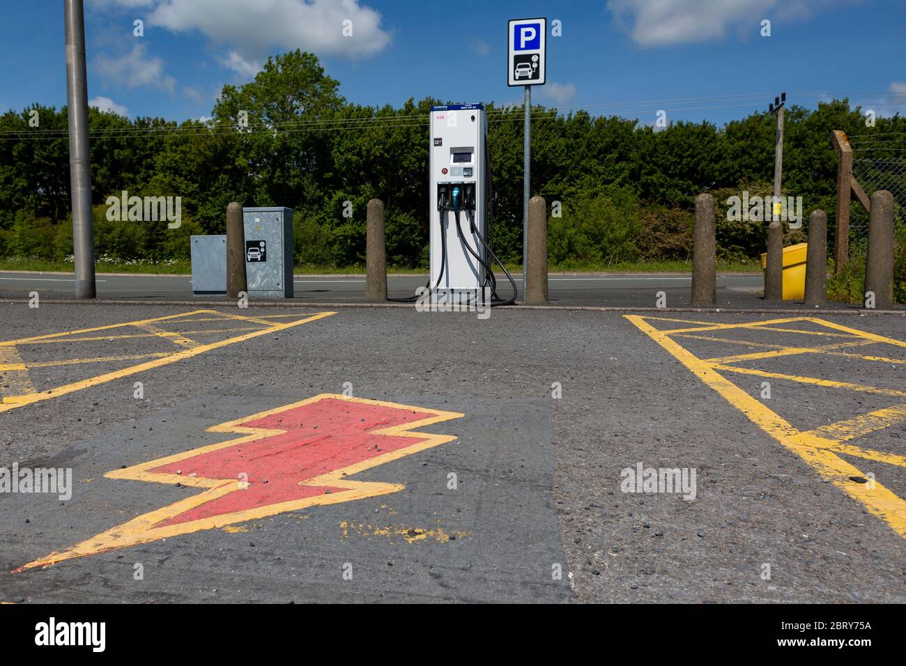 Electric car charging point with lightning symbol painted on ground ...