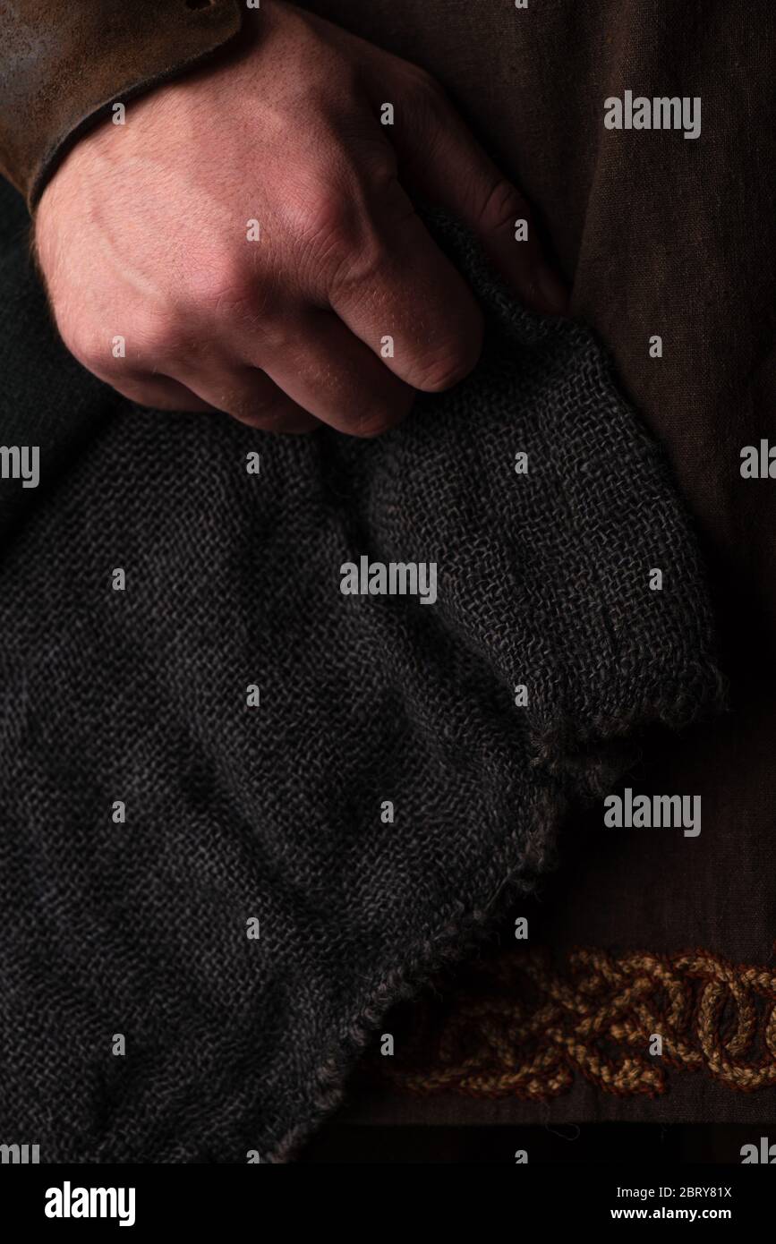 hand of medieval Scottish adult man in brown clothing Stock Photo - Alamy