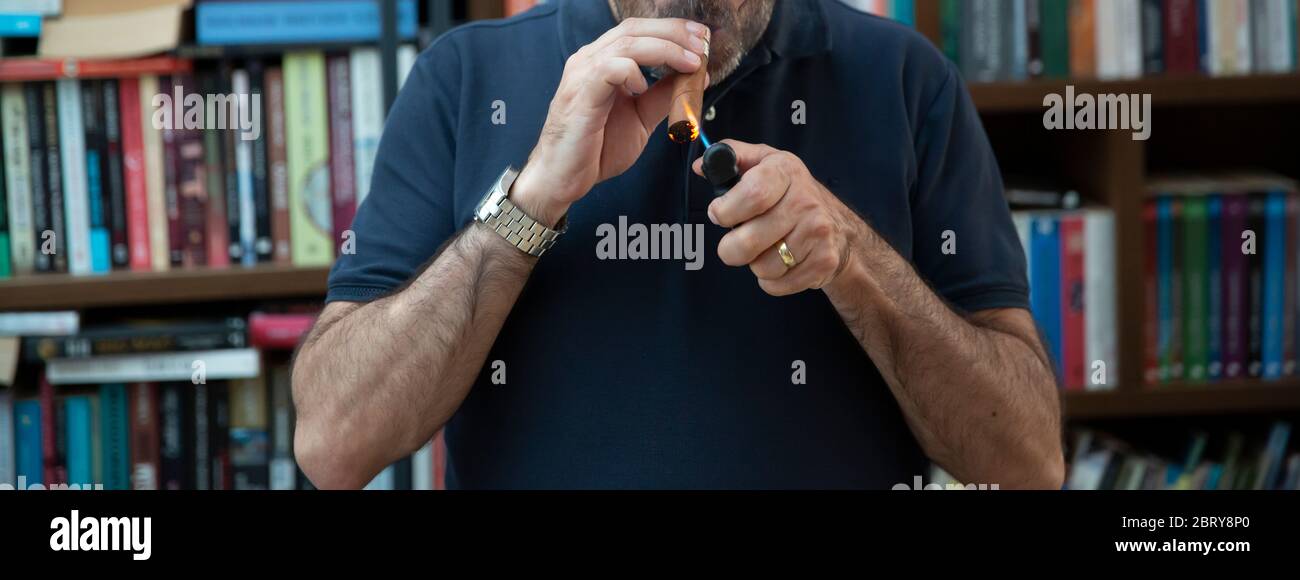 Man lights a cigar lighters from Stock Photo - Alamy