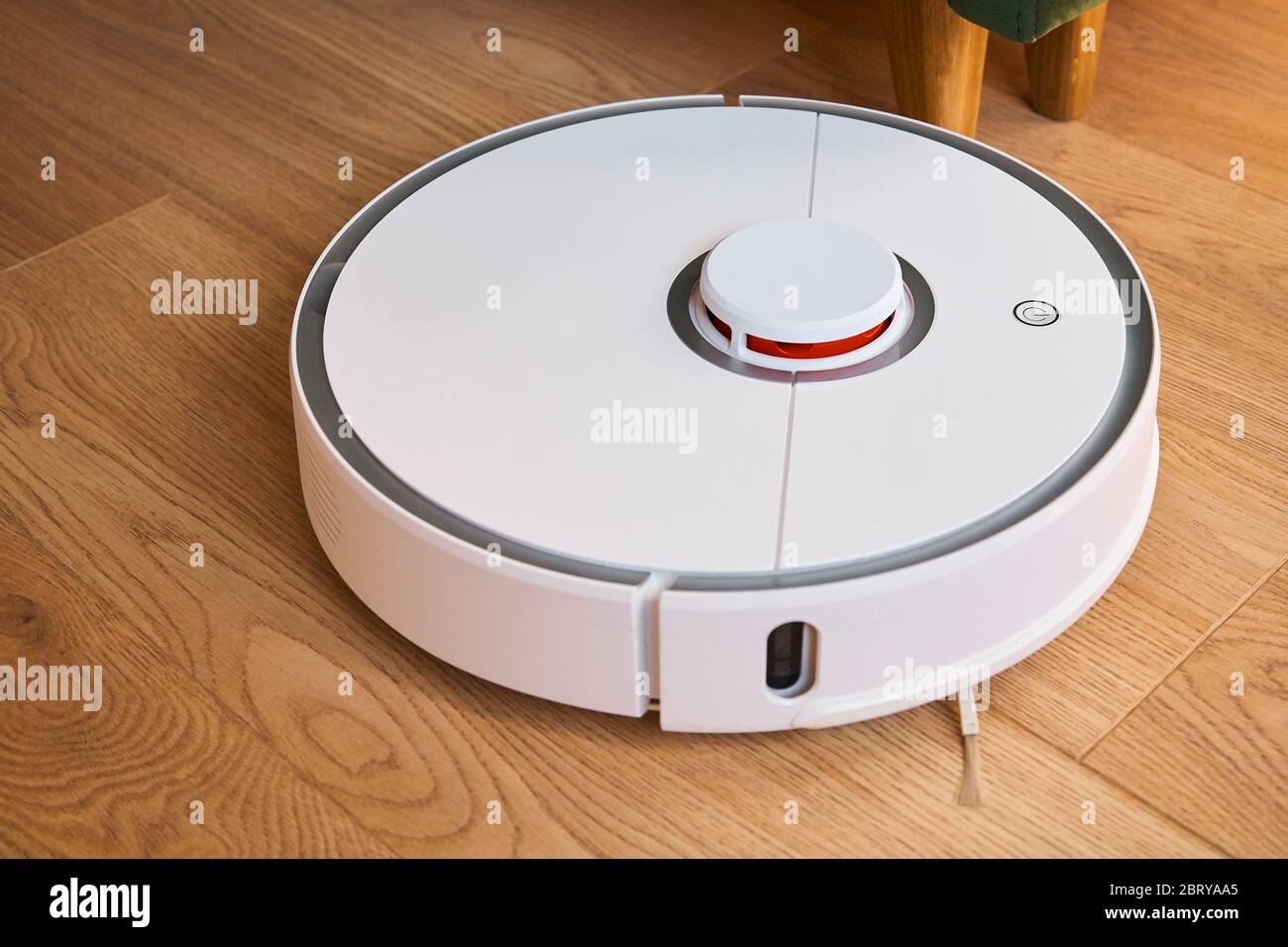 modern white robotic vacuum cleaner washing floor Stock Photo - Alamy