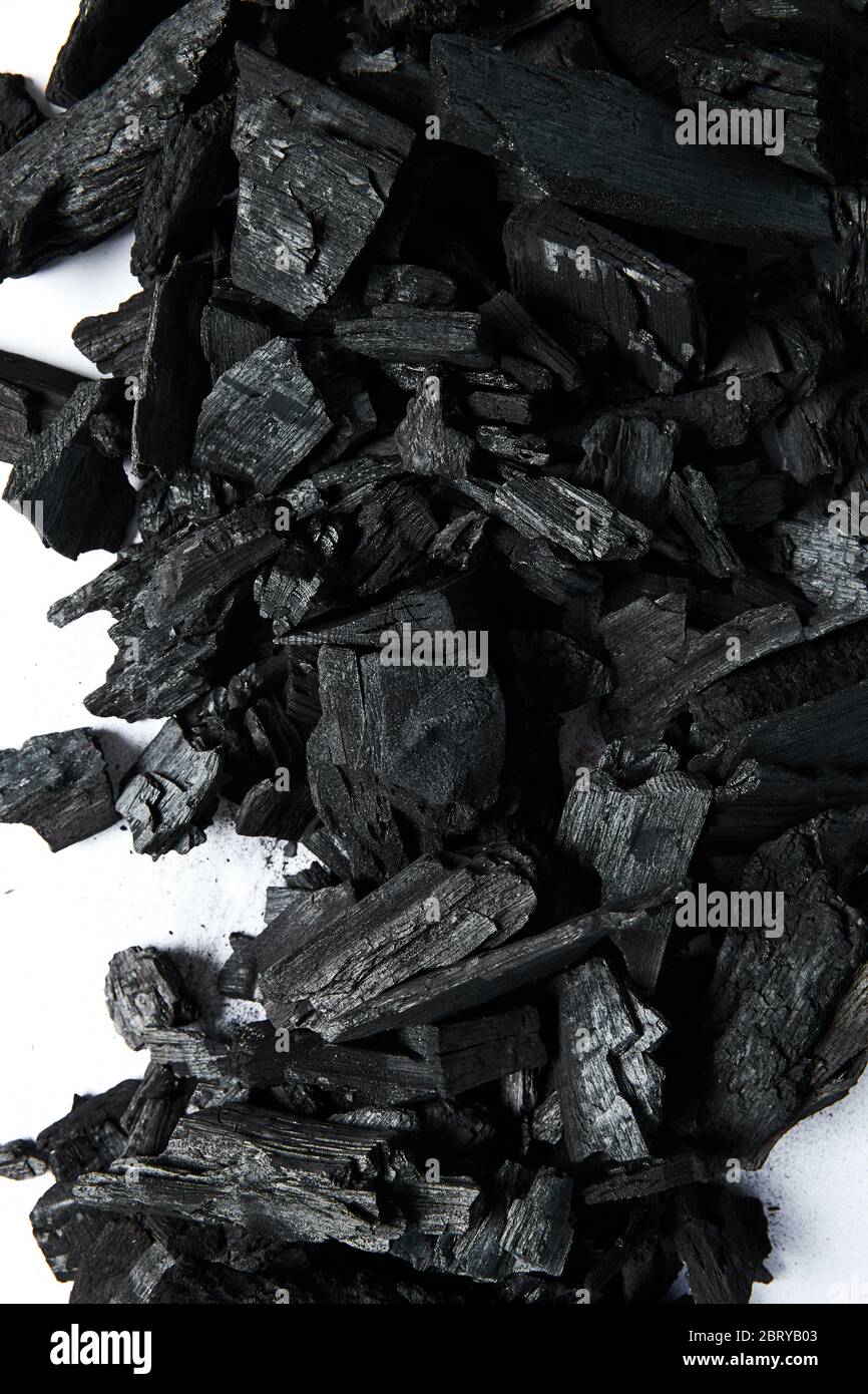 top view of black coals on white background Stock Photo - Alamy
