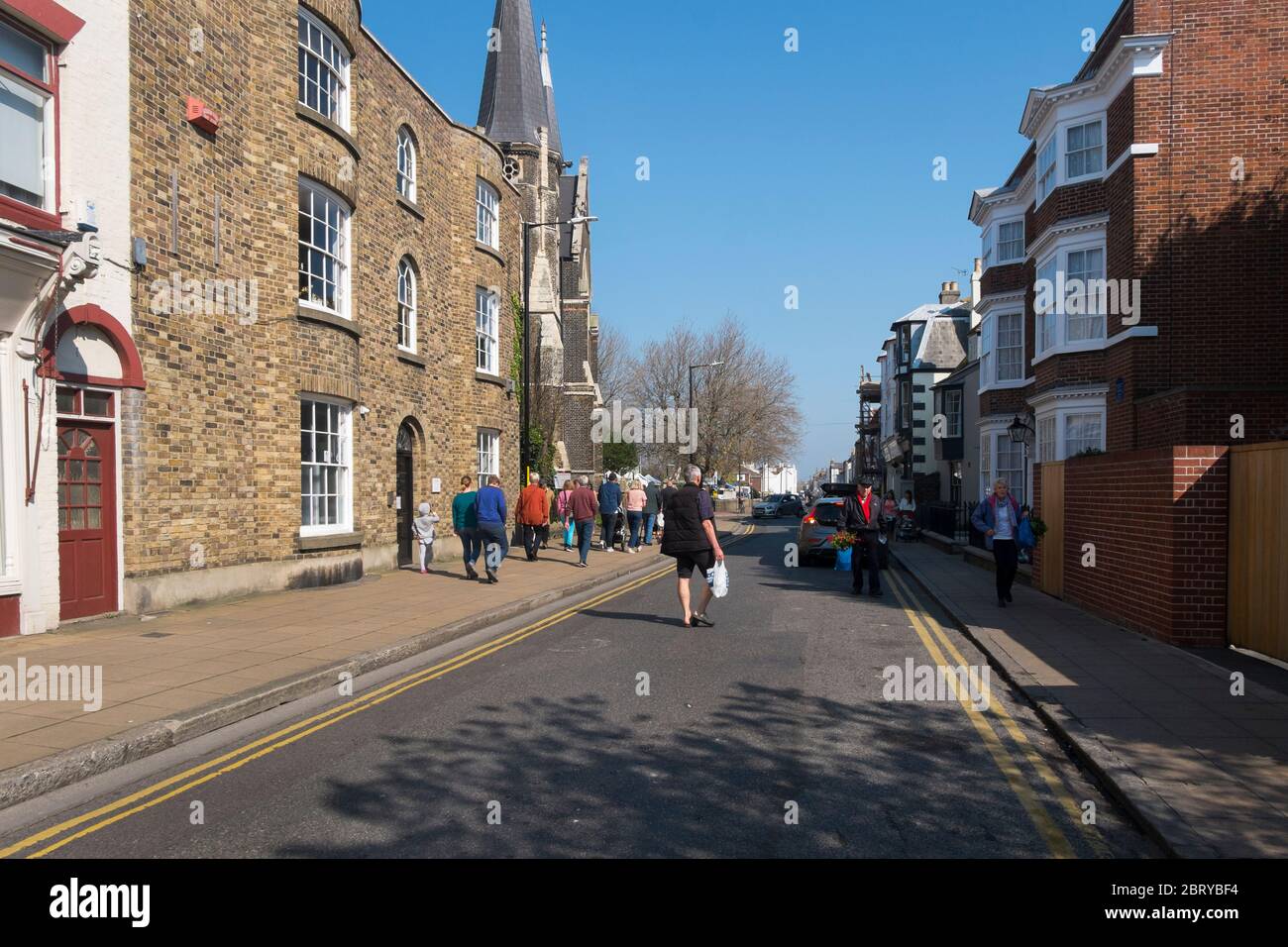 People walking along with flowers and produce from the weekly Saturday ...