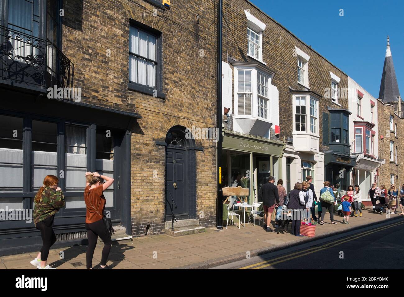 People walking along with flowers and produce from the weekly Saturday ...