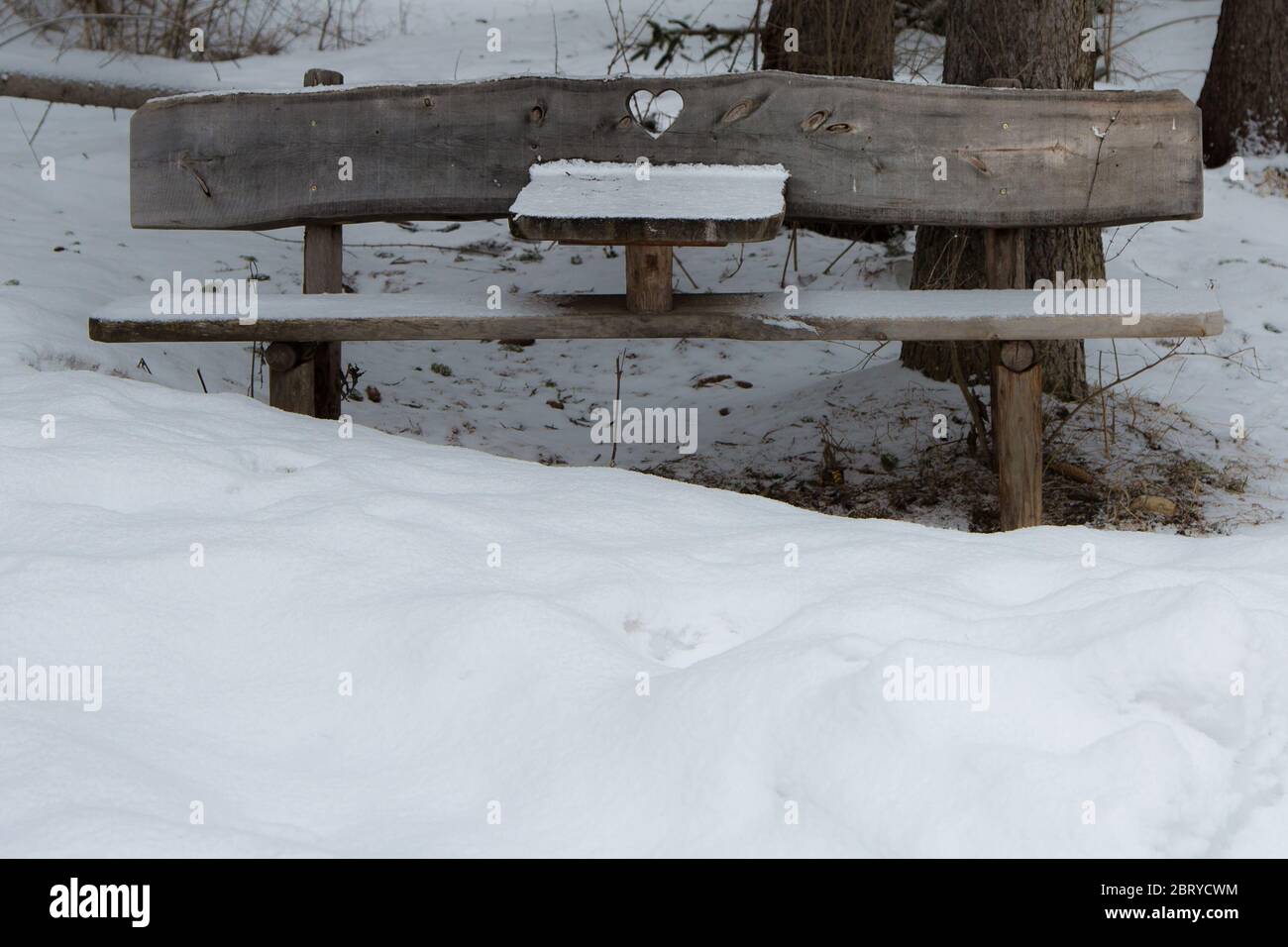 Wooden Bench with Heart Carved in wood Among Fresh Snow in Italian ...