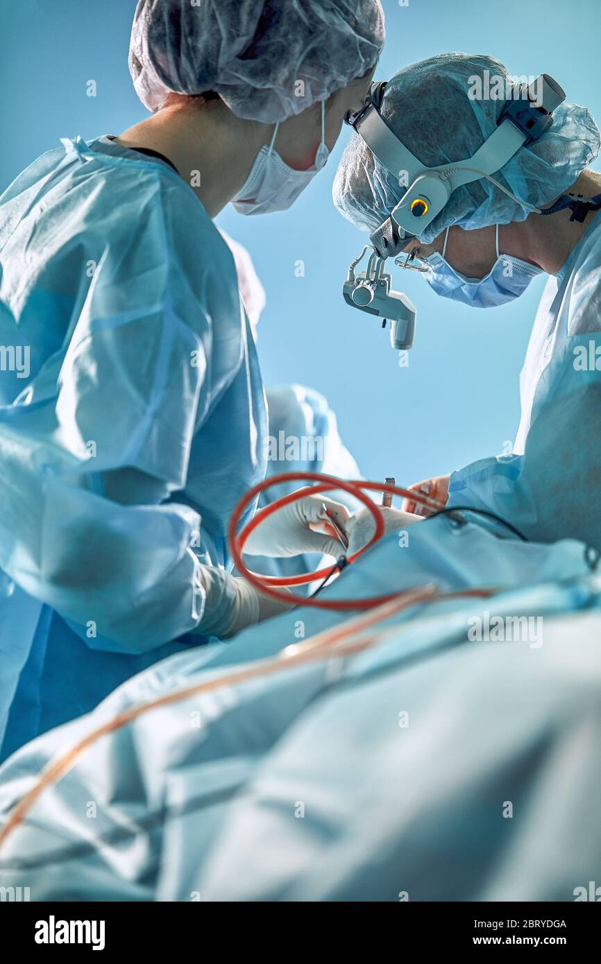 Surgeons team in the operating room, portraits close-up. modern ...