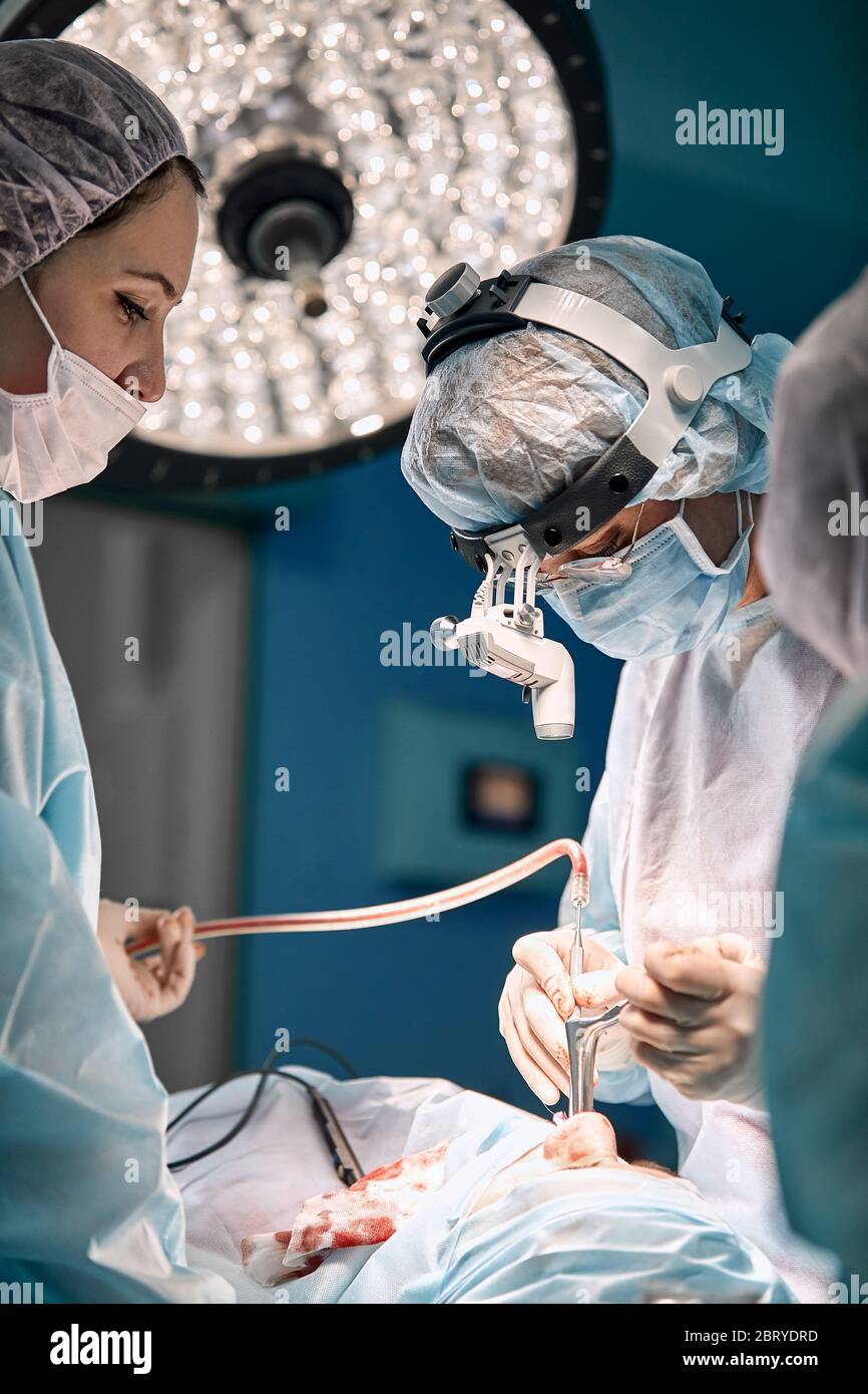 Team of women surgeons in the operating room. A modern team of doctors ...