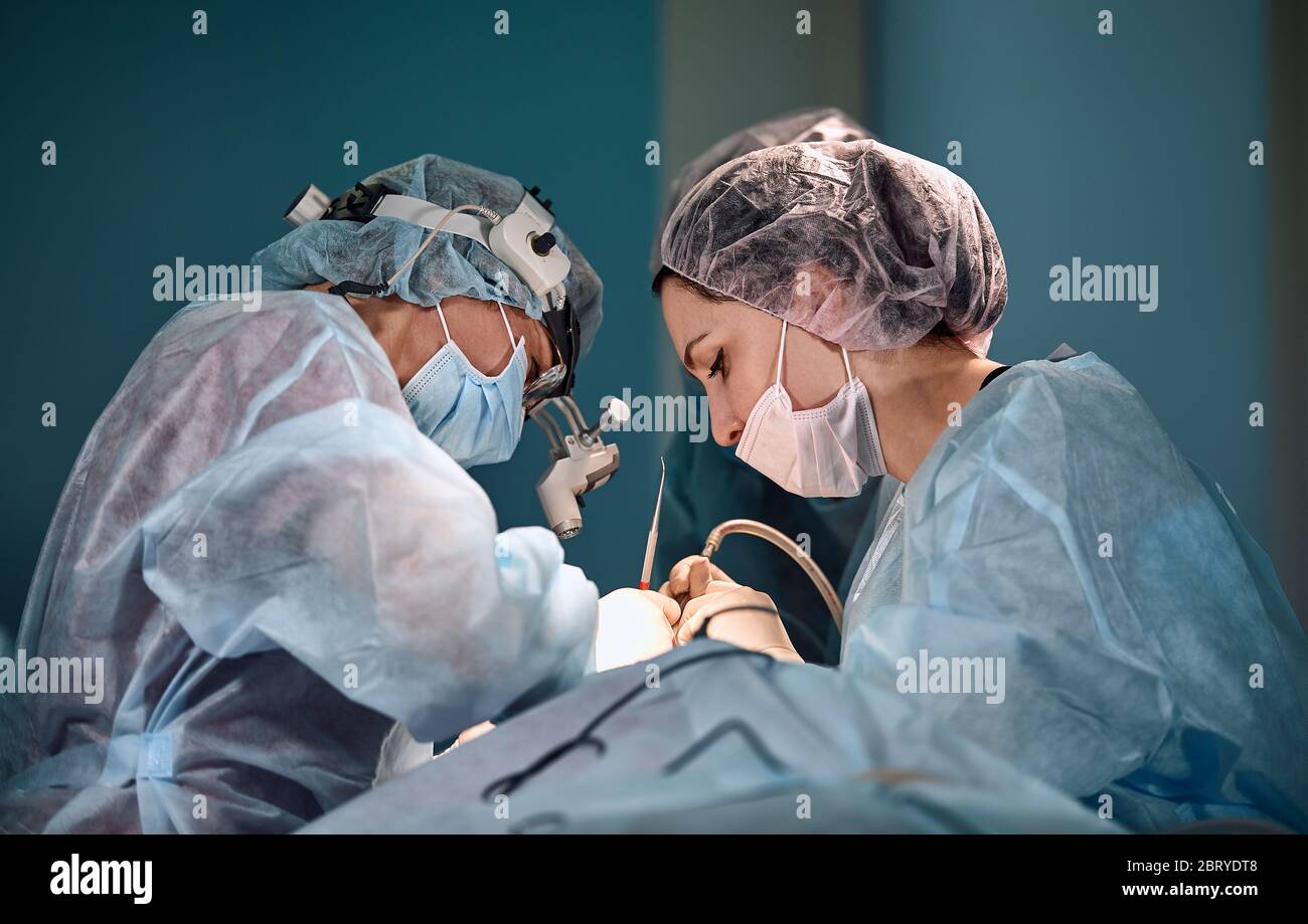Surgeons team in the operating room, portraits close-up. modern ...