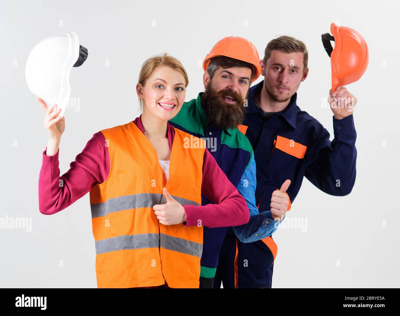 Builder, architect, engineer as friendly team. Woman and men holds hard ...