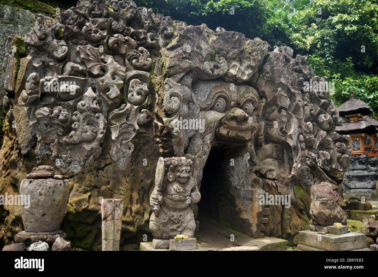Ancient sculpture carving gate entrance tunnel of Goa Gajah or Elephant ...