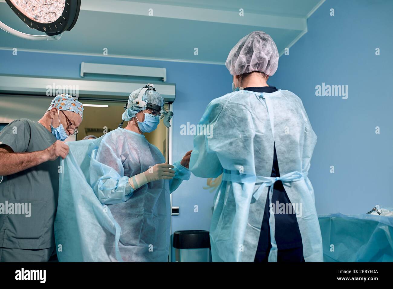 A team of surgeons is preparing for surgery. Surgeons wear sterile ... A team of surgeons is preparing for surgery. Surgeons wear sterile ...