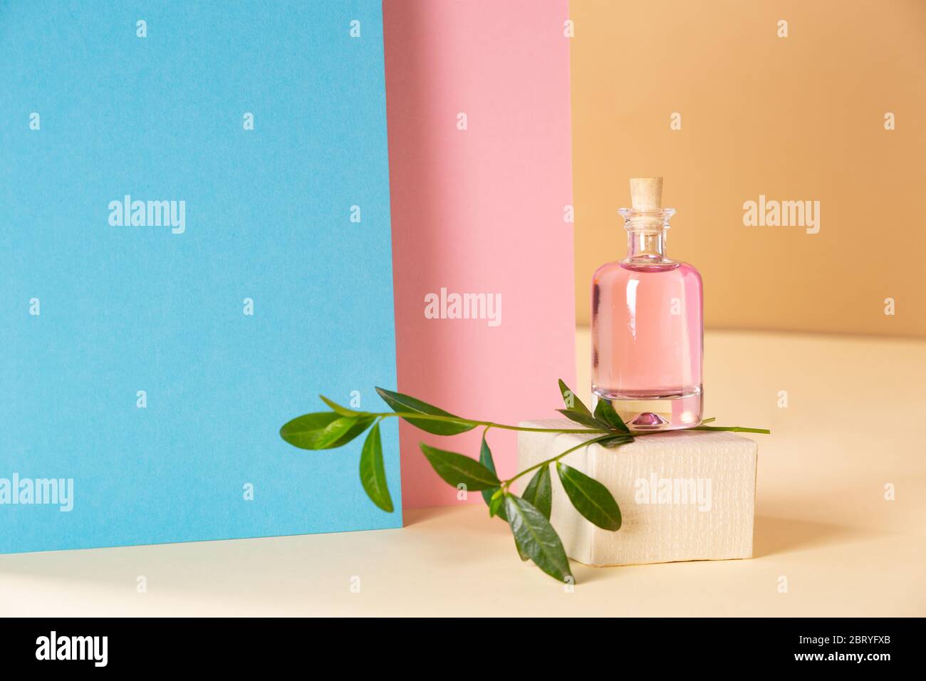 Bottle with perfume on a color geometric background Stock Photo - Alamy