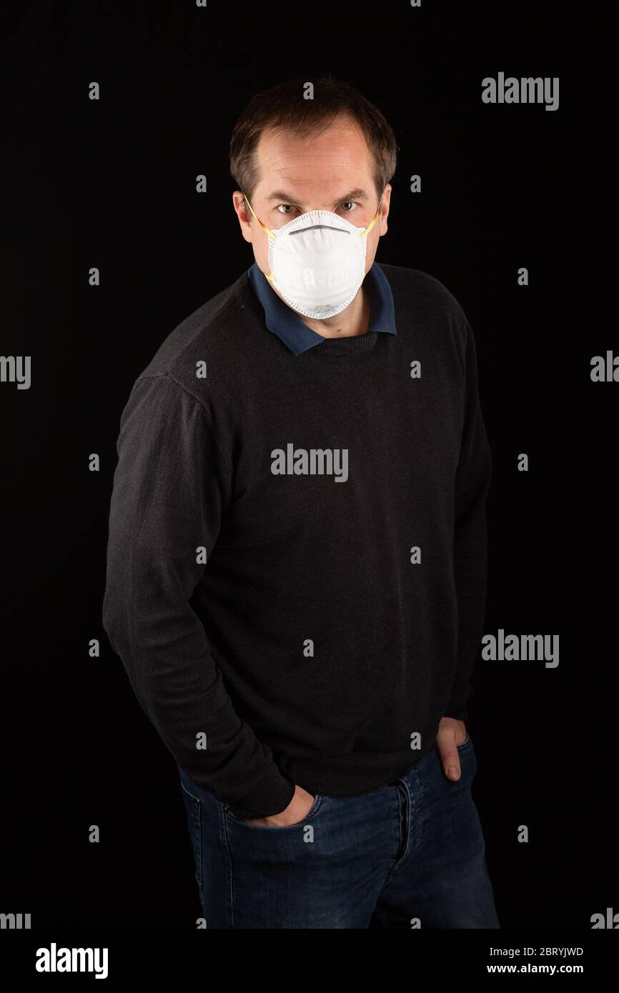A man wearing a medical face mask PPE, Personal Protective Equipment ...