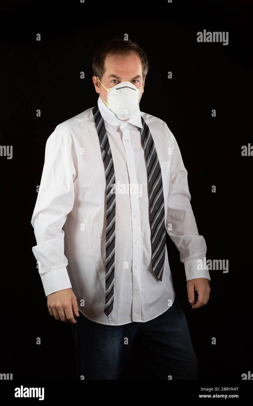 man with a tie hanging around his neck wearing a face mask Stock Photo ...