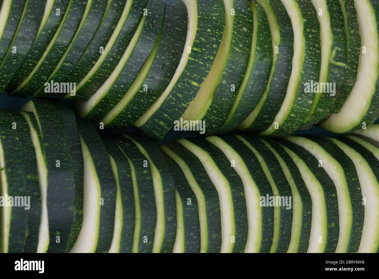 green courgette cut in many slices Stock Photo - Alamy