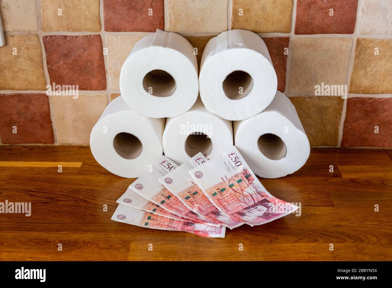 A pile of cash next to some toilet rolls, toilet paper shortage due to ...