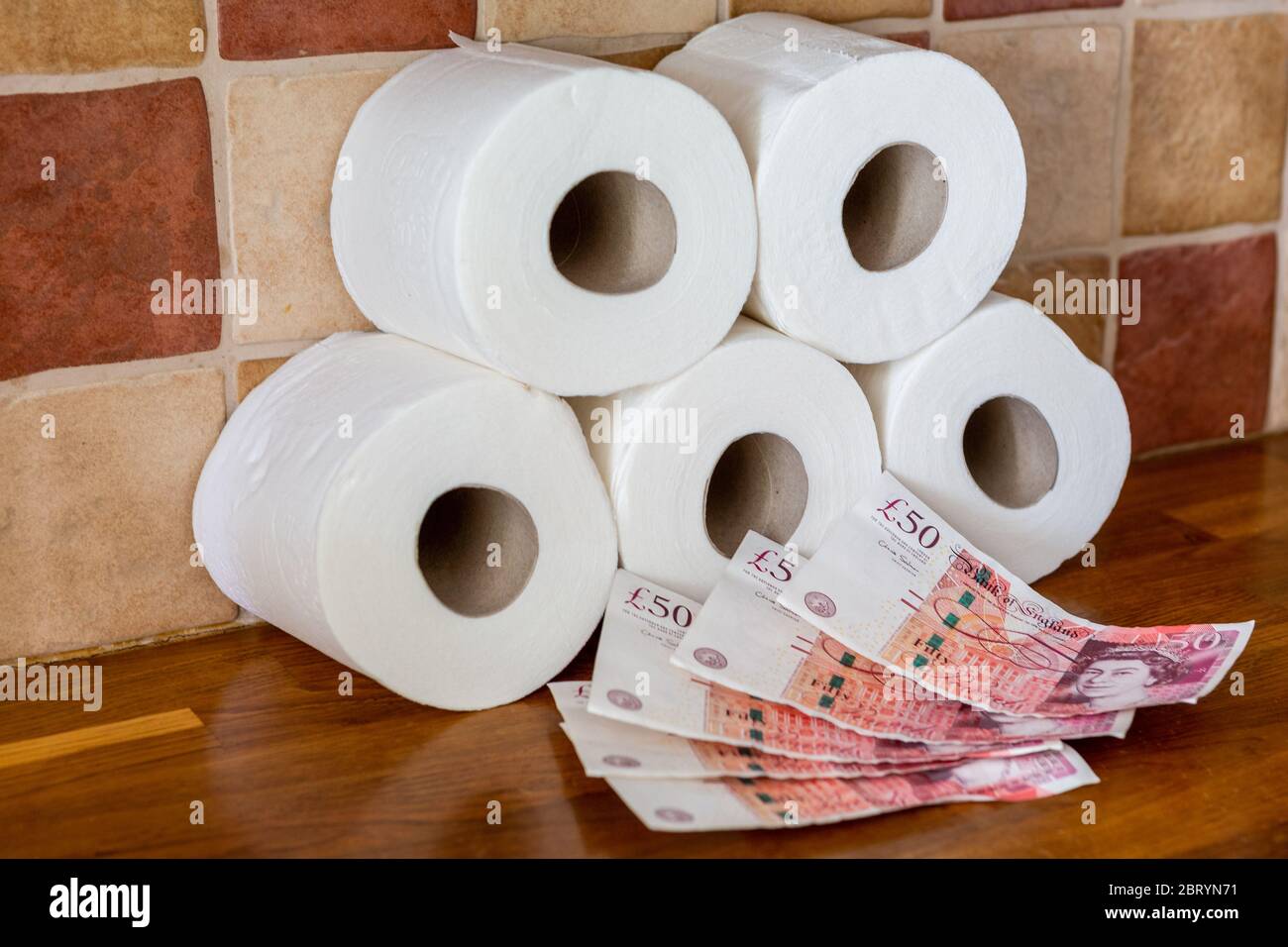 A pile of cash next to some toilet rolls, toilet paper shortage due to ...