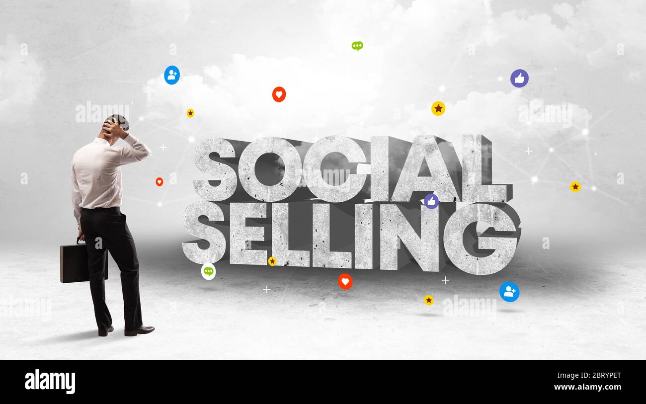 Young businessman standing in front of SOCIAL SELLING inscription ...
