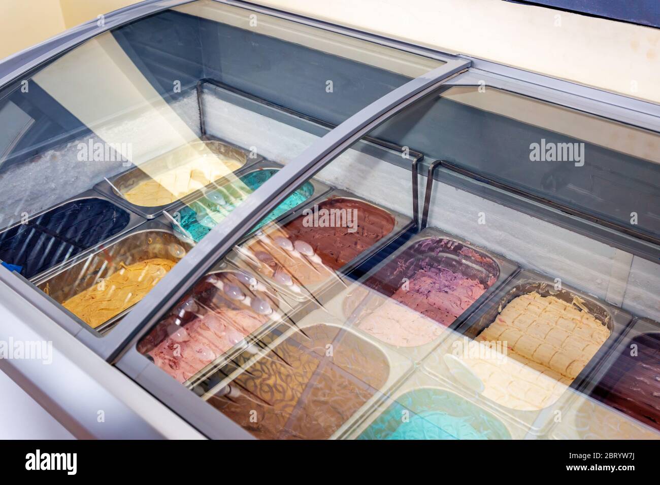 Ice cream serving counter with many scoopable flavors.Assorted Flavors ...