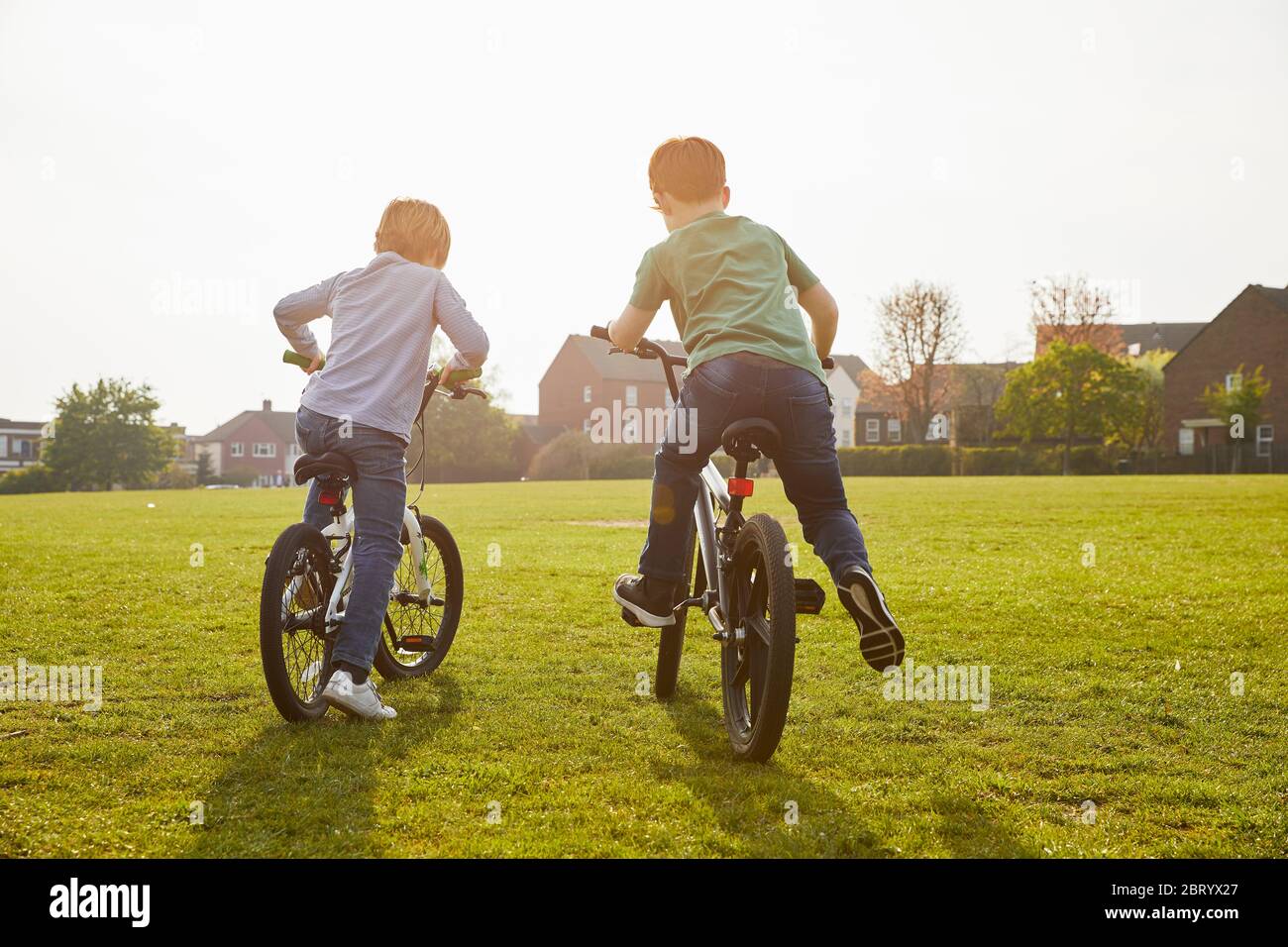 Two boys riding their BMX bikes in a park Stock Photo - Alamy