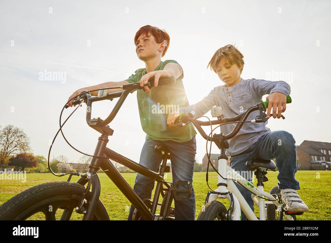 Two boys riding their BMX bikes in a park Stock Photo - Alamy