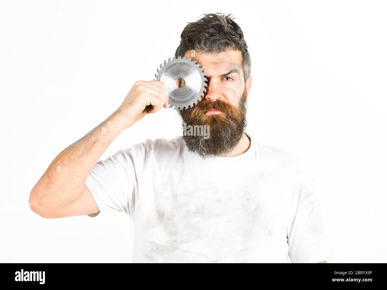 Repairman, foreman holds circular saw blade in front of his face. Sharp ...