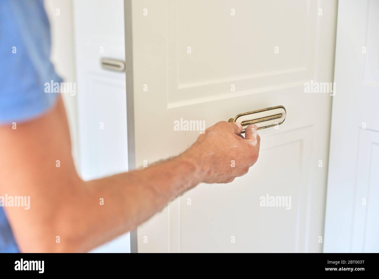 Installation of new cabinet, handyman sets door handles Stock Photo - Alamy