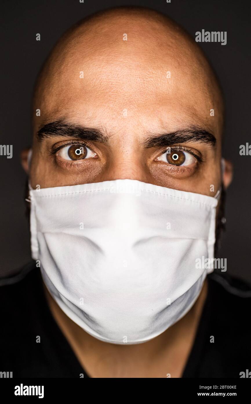 A man wearing a face mask covering his nose and mouth Stock Photo - Alamy