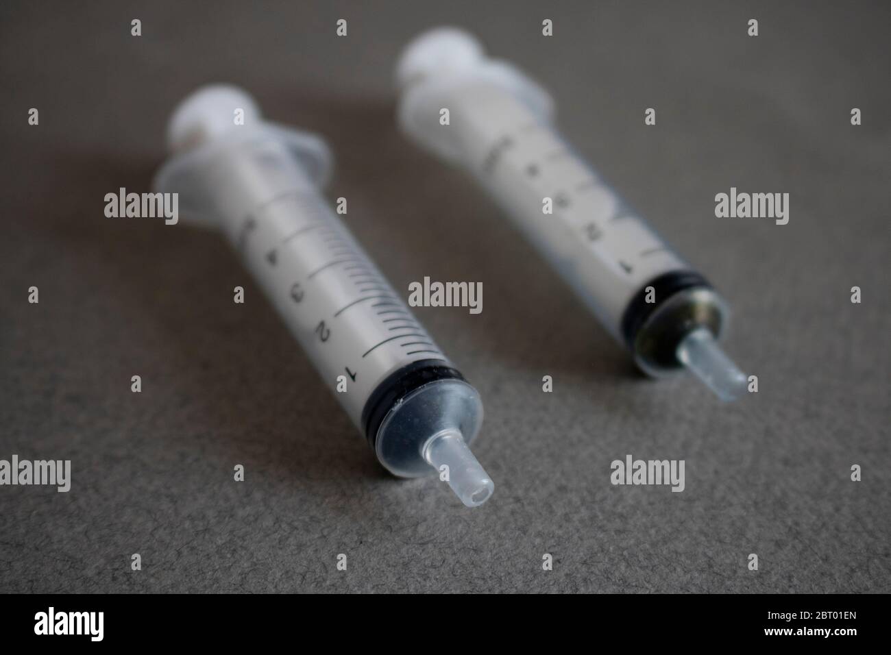 some small syringes on a grey paper, view above Stock Photo - Alamy