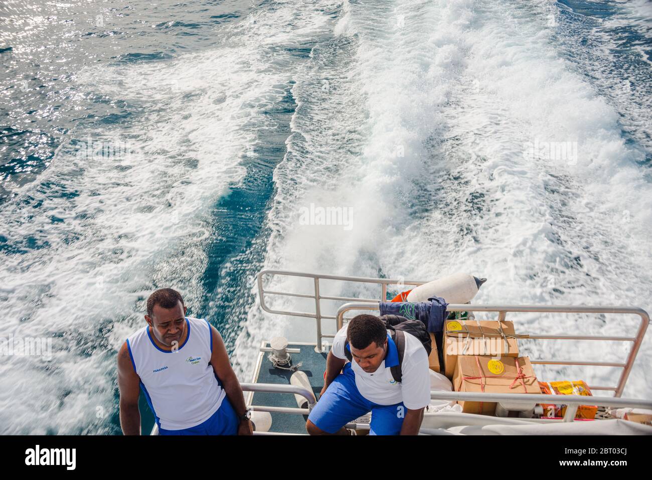 Fijian men standing on the ships stern. View from above on a cruise in ...