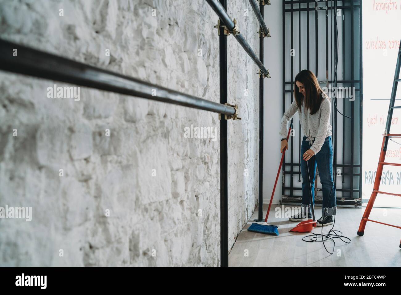 Woman sweeping floor hi-res stock photography and images - Alamy