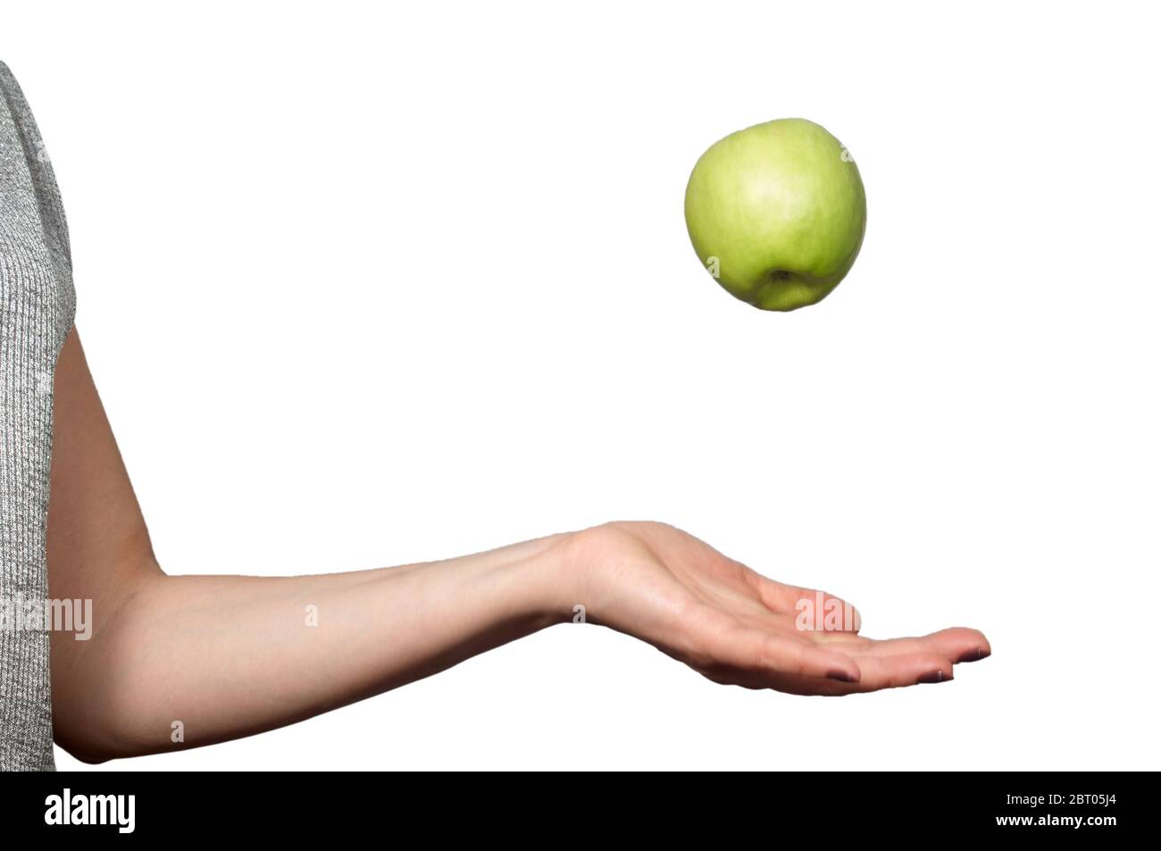 Hand tossing green apple in the air Stock Photo - Alamy