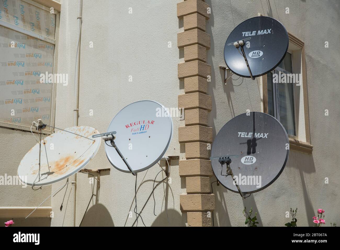 Satellite dishes on the old house. Satellite TV on the wall of a ...