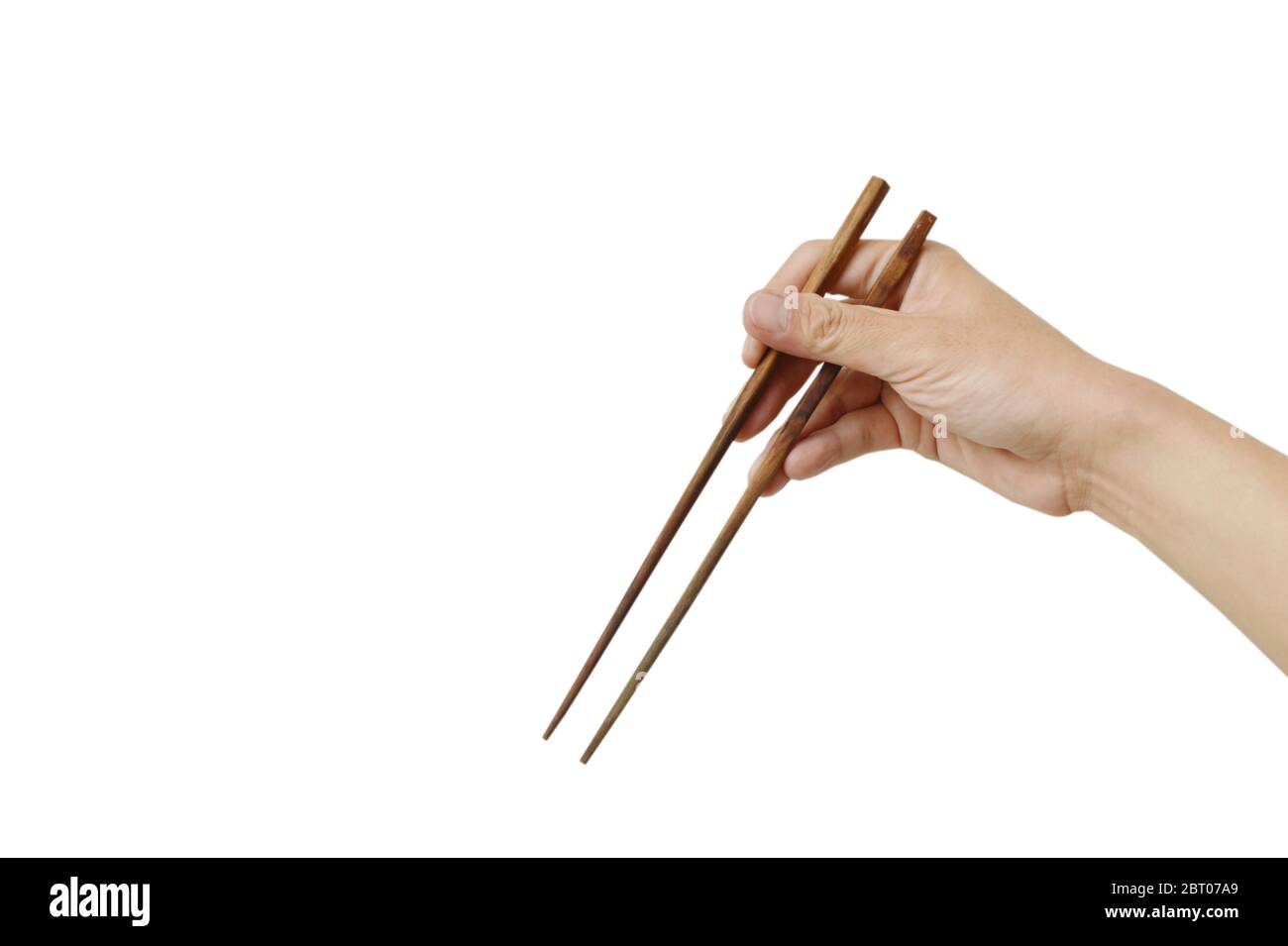 hand holding and use wooden chopsticks on white background Stock Photo ...