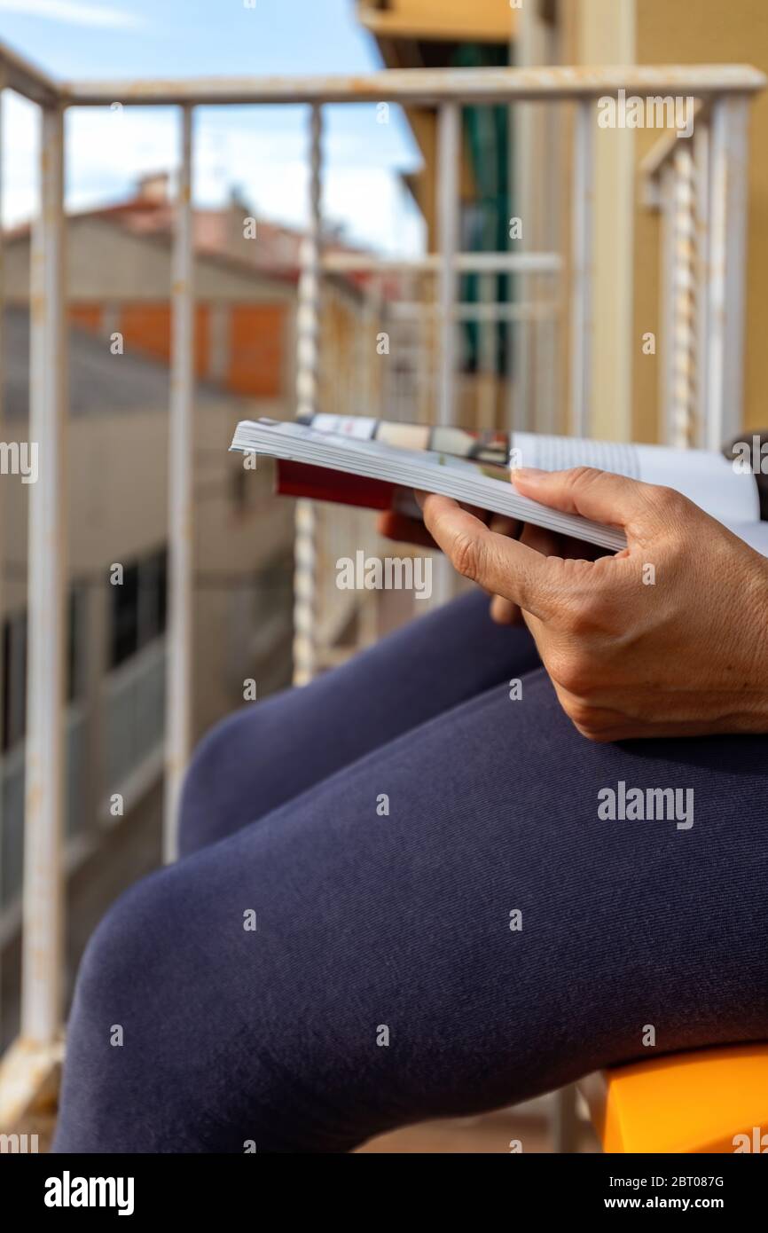 Person on home balcony reading hi-res stock photography and images - Alamy