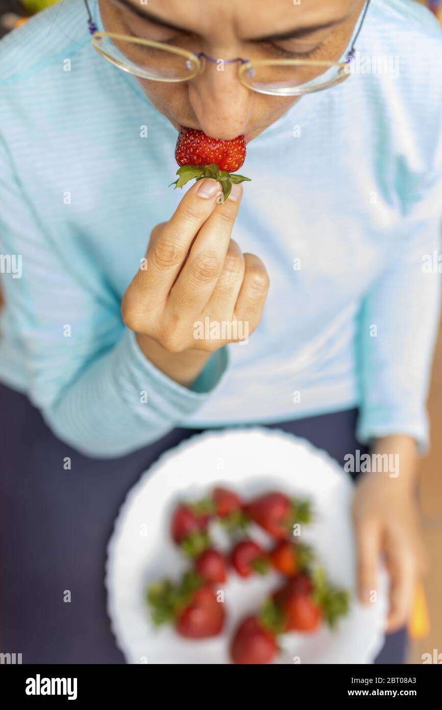 Woman mouth eating strawberry hi-res stock photography and images - Alamy