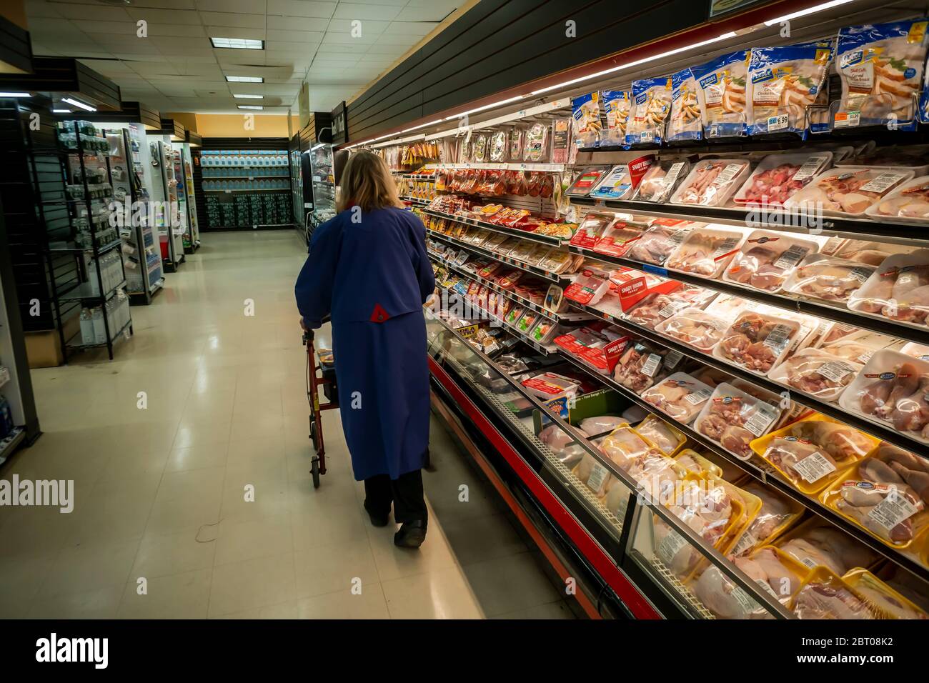 Senior citizen in the butcher department of a supermarket in New York ...