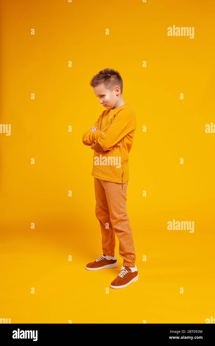 upset boy standing with arms crossed Stock Photo - Alamy