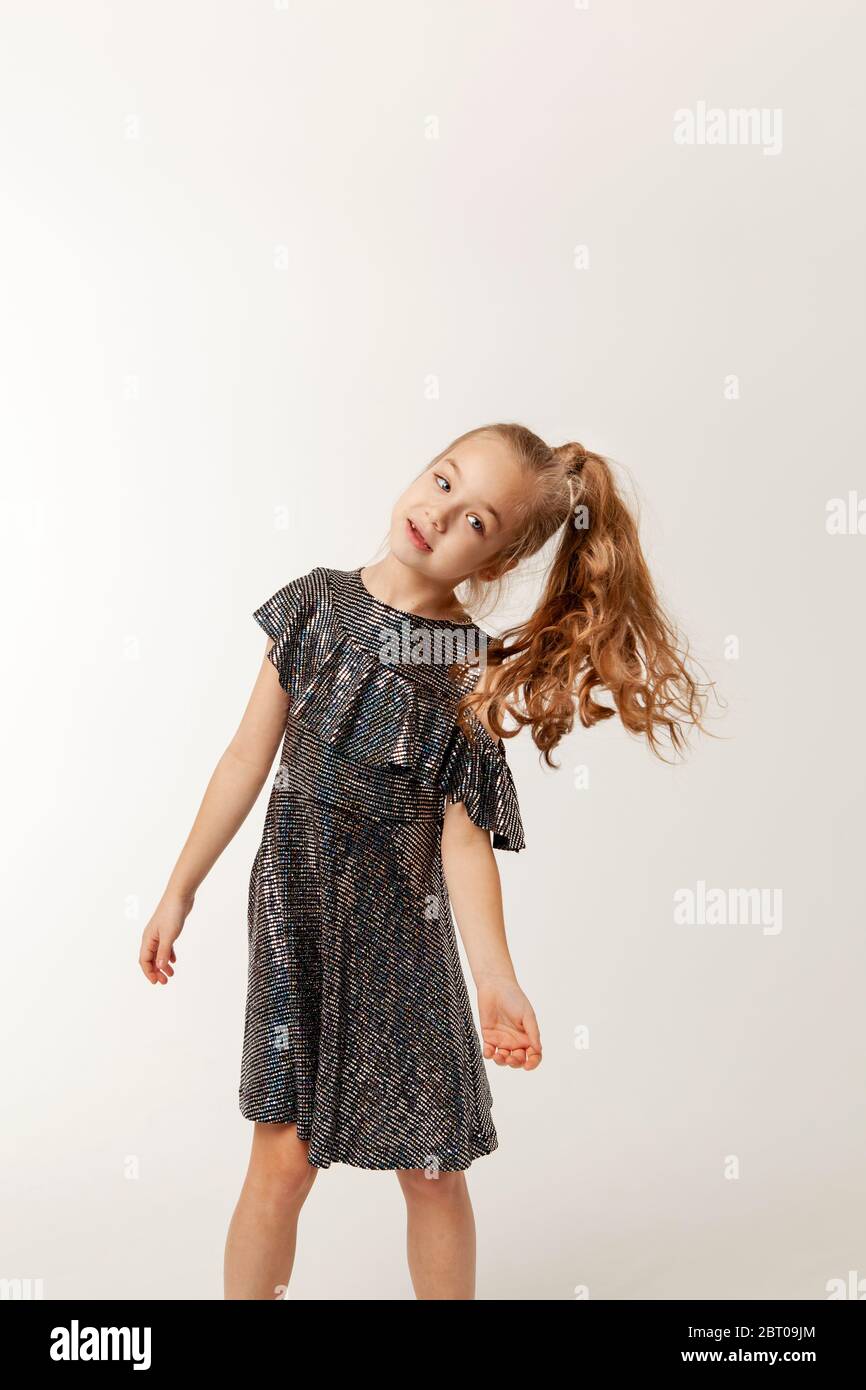 Little girl in sequin dress is dancing Stock Photo - Alamy