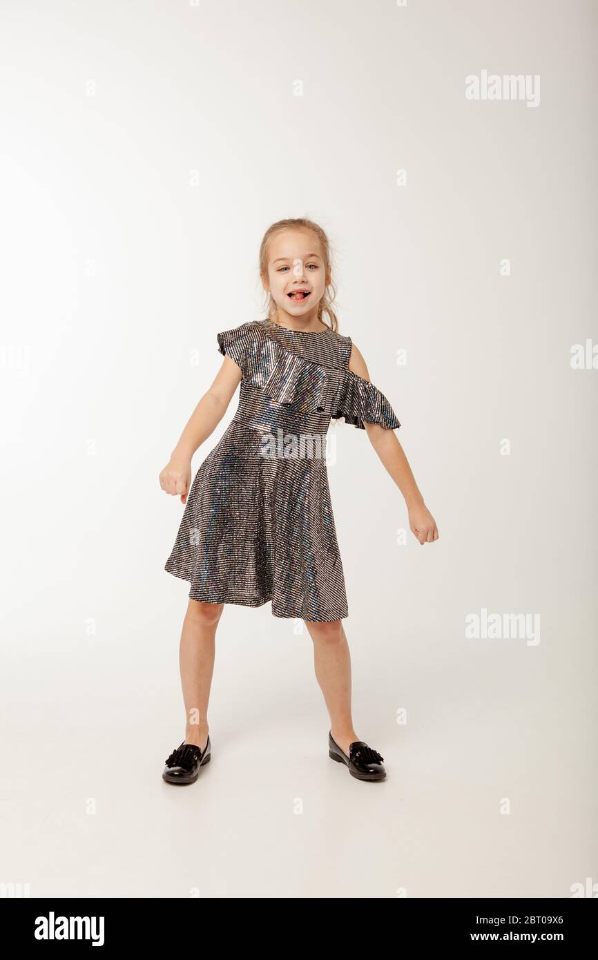 Little girl in sequin dress is dancing Stock Photo - Alamy