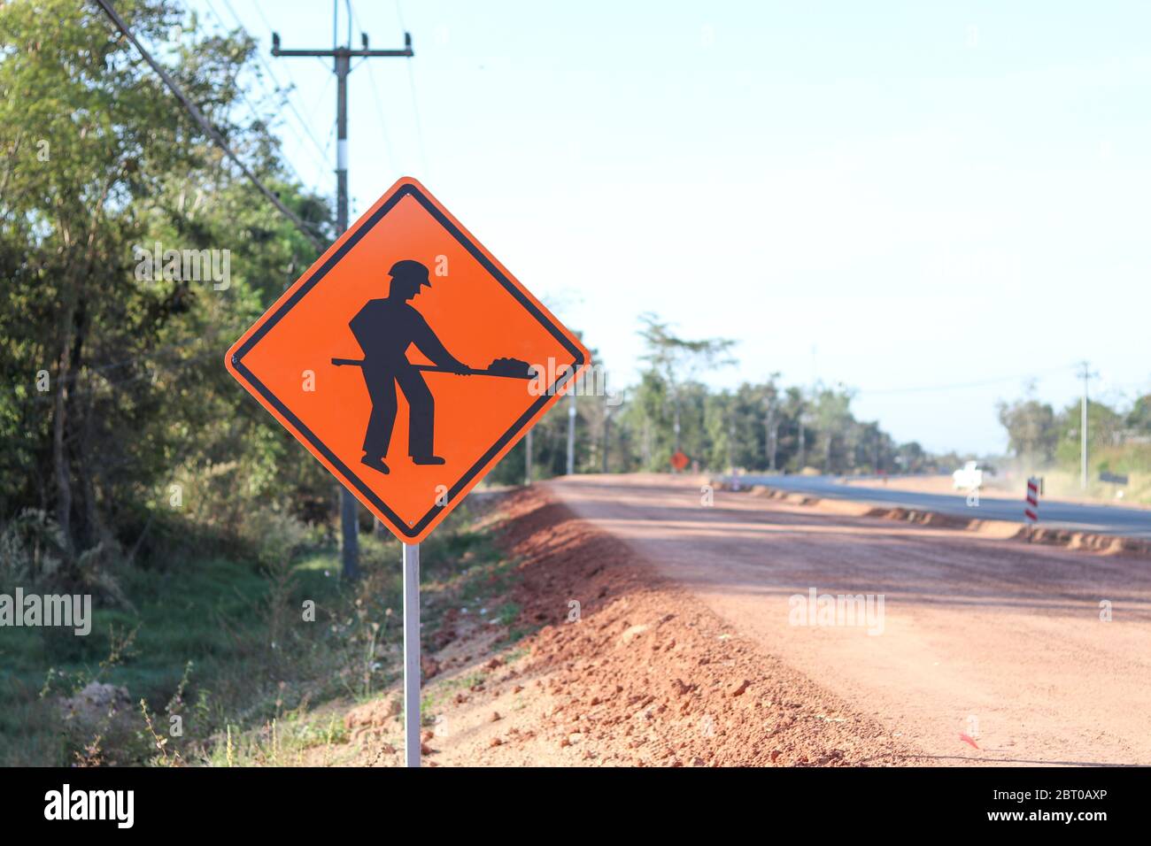 The orange sign shows a symbol with the image of a person holding a ...
