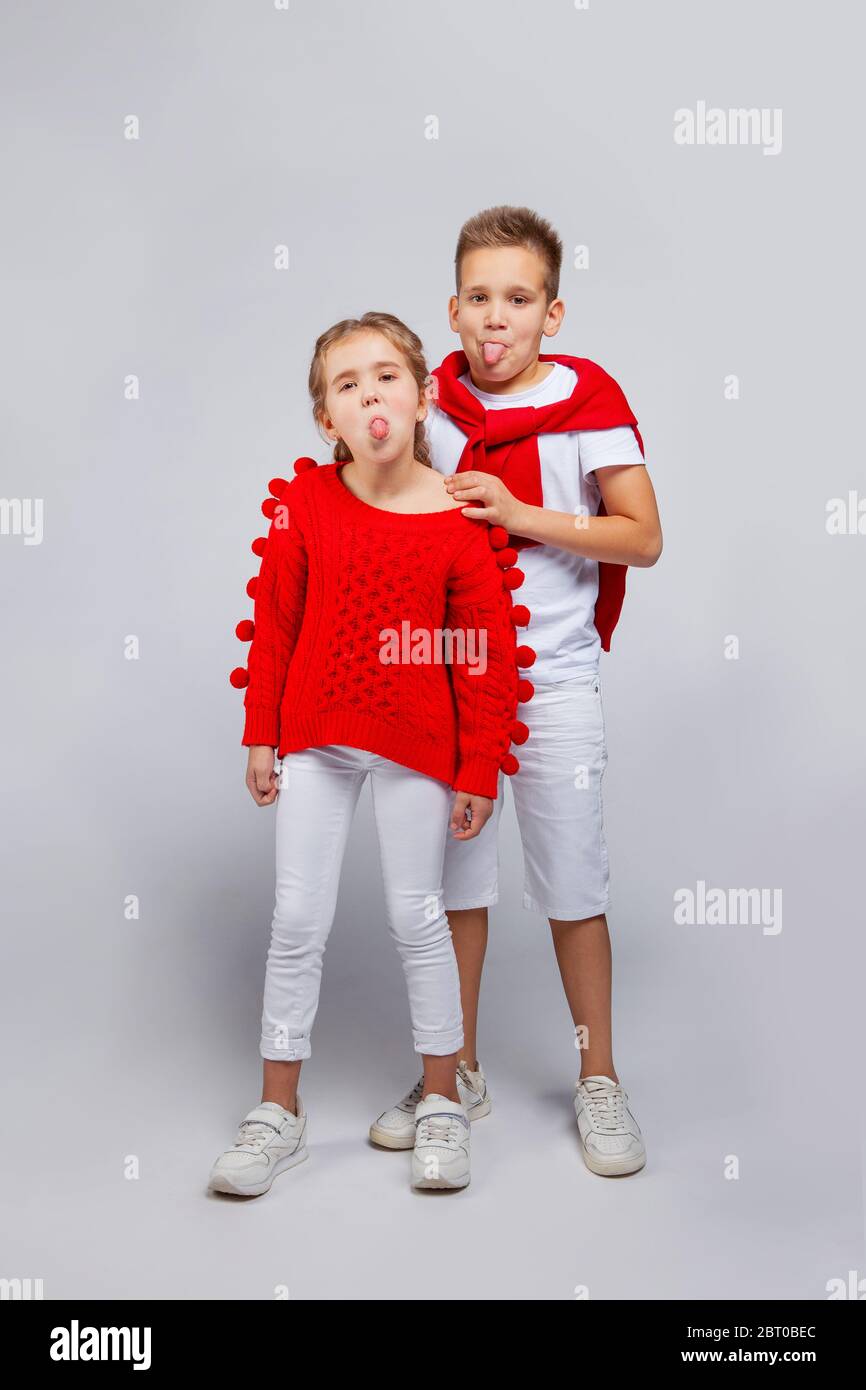 friends dressed in red and white clothes show tongues Stock Photo - Alamy
