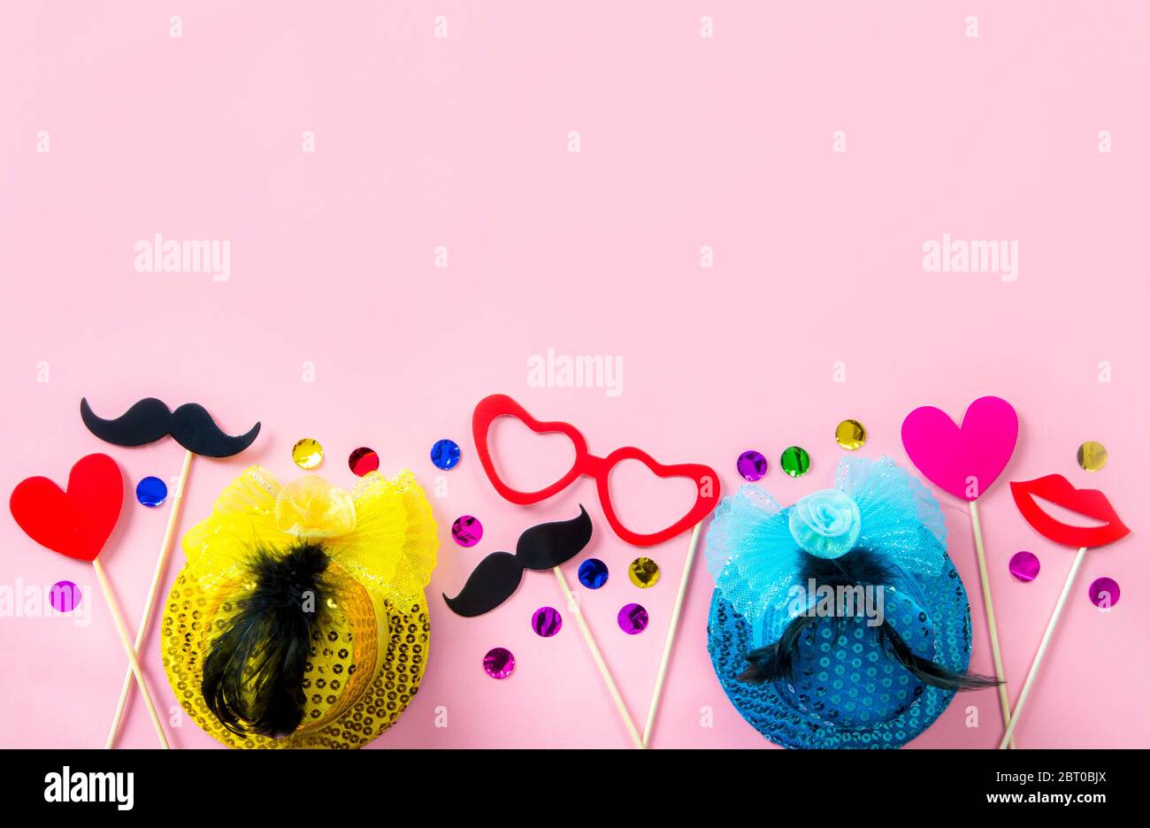 Flat lay view of pink background with fun birthday party decorations ...