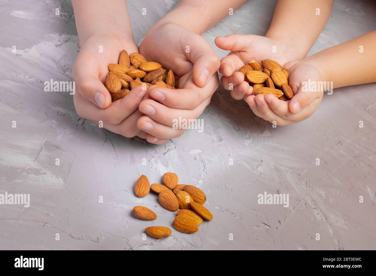 Healthy eating concept. Boy and girl holding organic almonds Stock ...