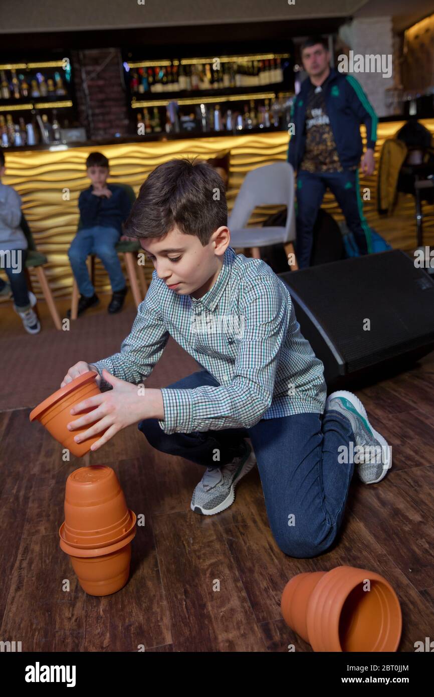 children play a race to stack a bowl on top of each other. Kids Playing ...